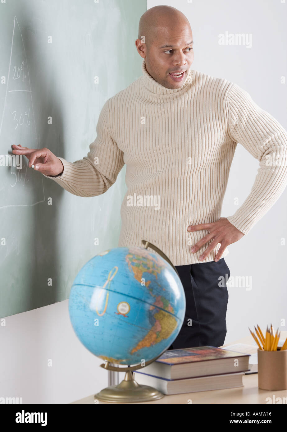 Male teacher at chalkboard Stock Photo - Alamy
