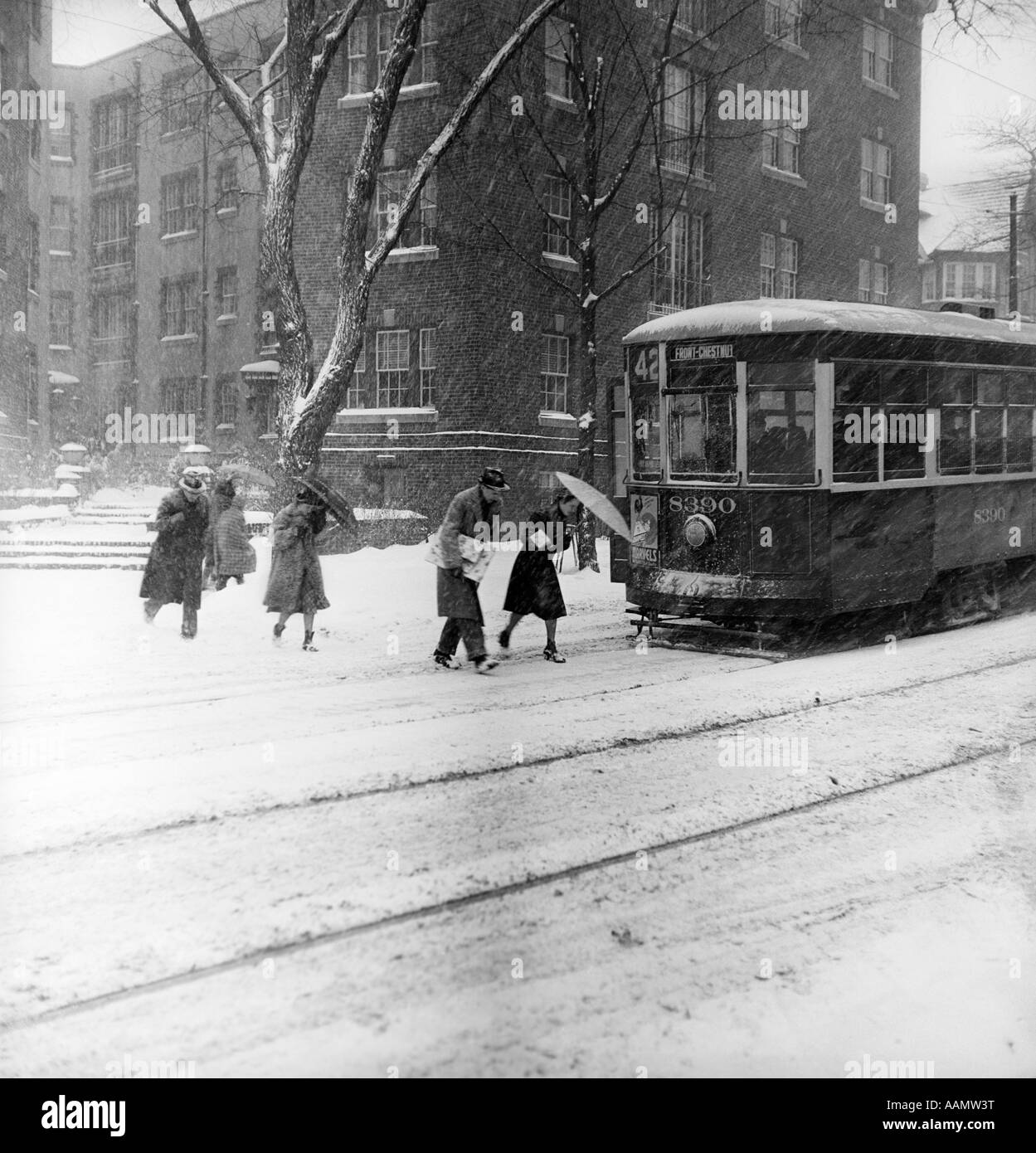 1930s 1940s CITY WINTER SCENE PEDESTRIANS CROSSING STREET SNOW TROLLEY ...