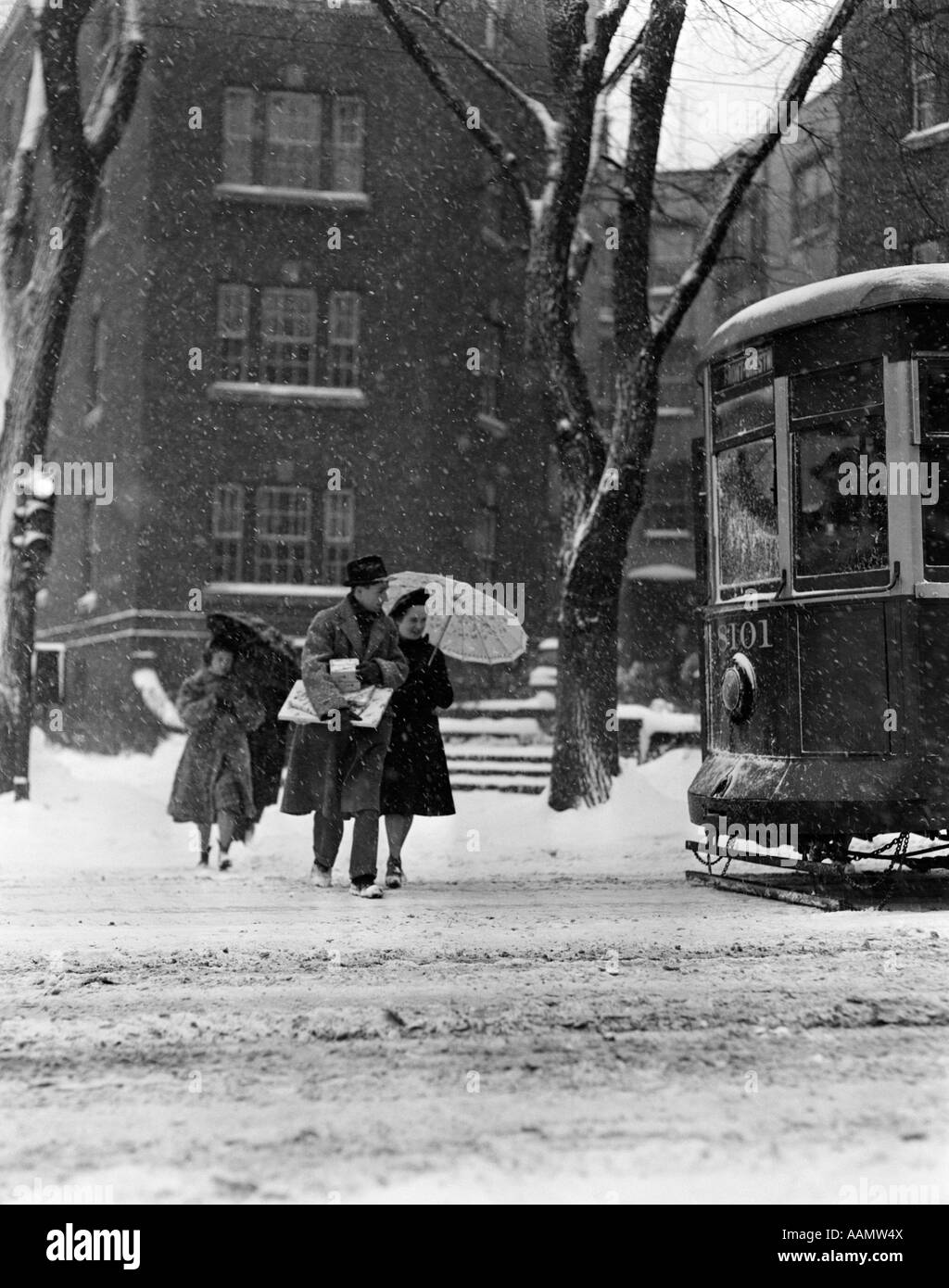1940s PEDESTRIANS WALKING IN SNOW WINTER WITH UMBRELLA PACKAGES 43rd ...