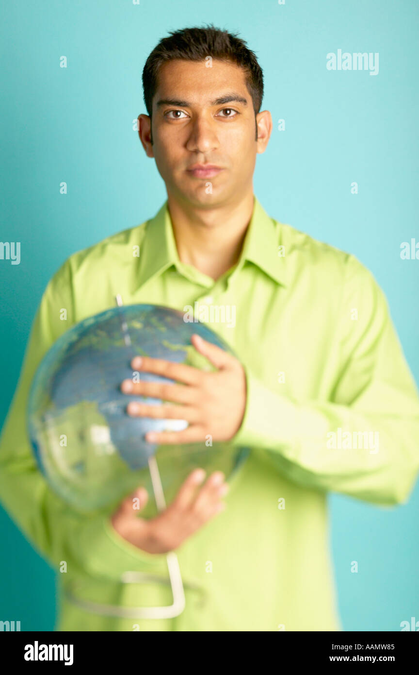 Portrait of man holding globe Stock Photo - Alamy
