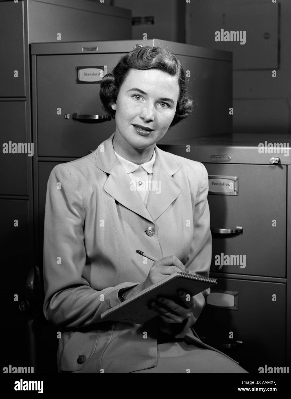1950s WOMAN NOTES BUSINESS SECRETARY FILING CABINET SUIT Stock Photo ...