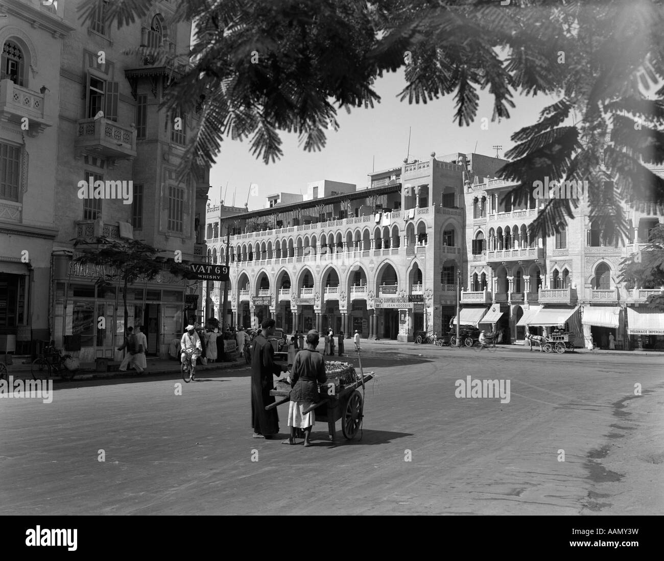 1920s 1930s STREET SCENE ARCHITECTURE IN ARAB STYLE VENDER PUSHING CART ...