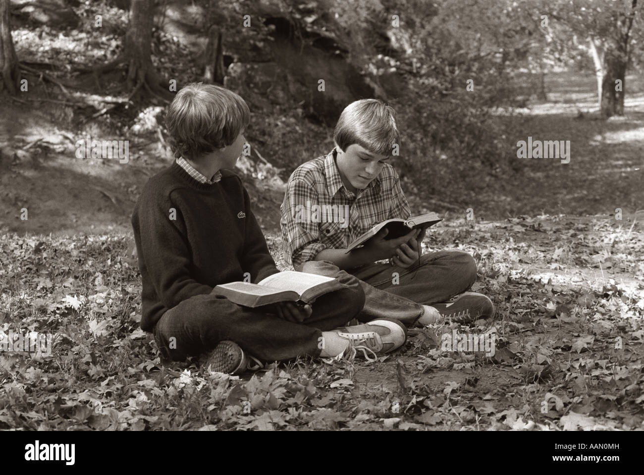 1970s TWO BOYS READING BIBLES OUTDOORS AUTUMN Stock Photo - Alamy
