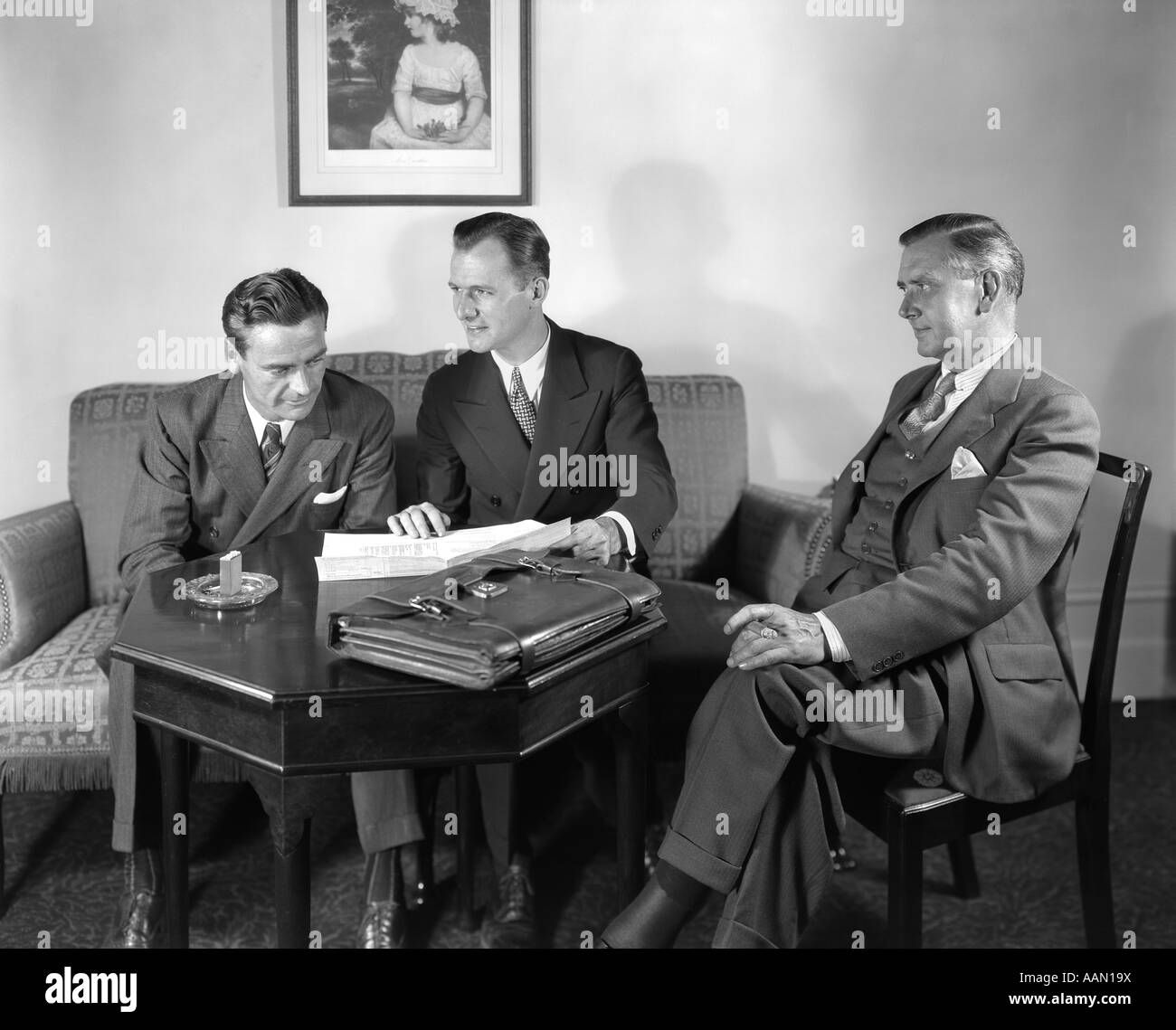 Small group of people sitting Black and White Stock Photos & Images - Alamy