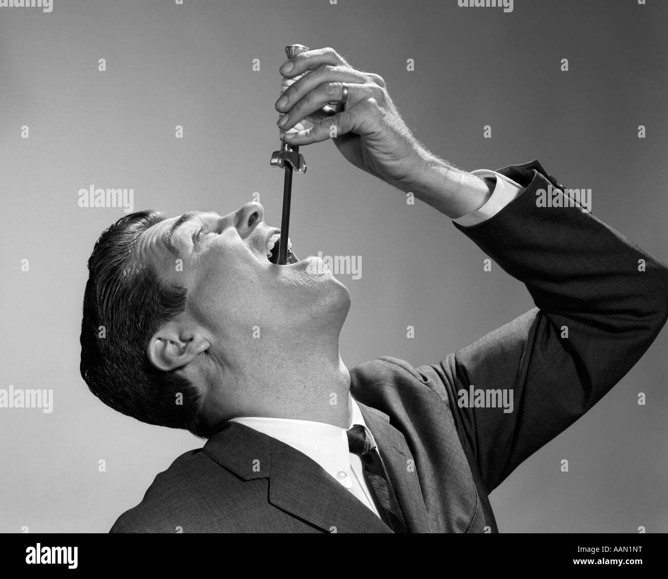 1960s BUSINESSMAN SWALLOWING SWORD Stock Photo - Alamy