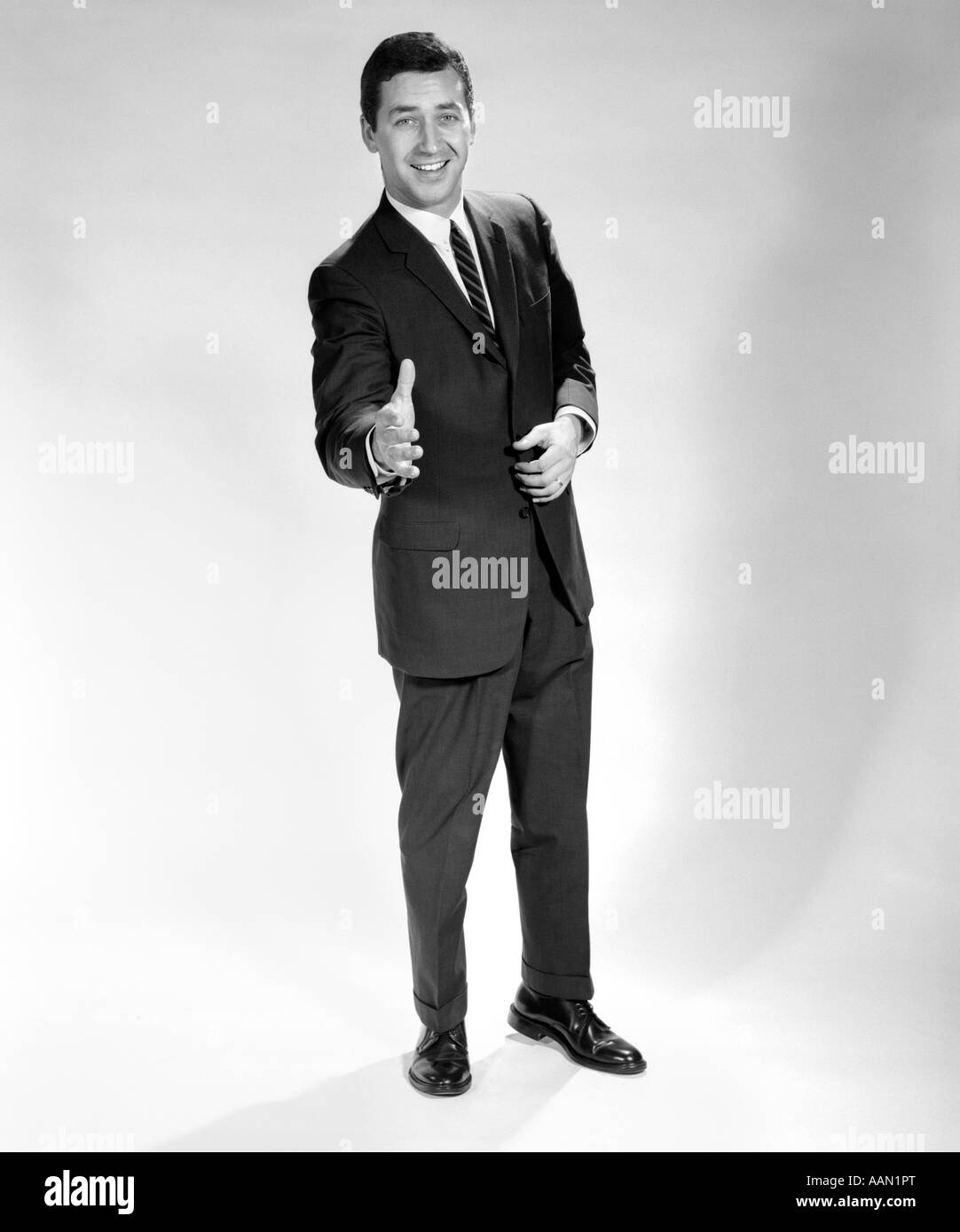 1960s SMILING FULL LENGTH PORTRAIT MAN BUSINESS MAN WITH HAND EXTENDED ...
