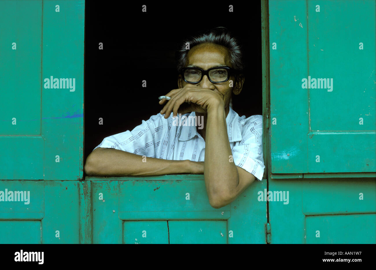 Man Leaning out of his window, Java, Indonesia Stock Photo - Alamy