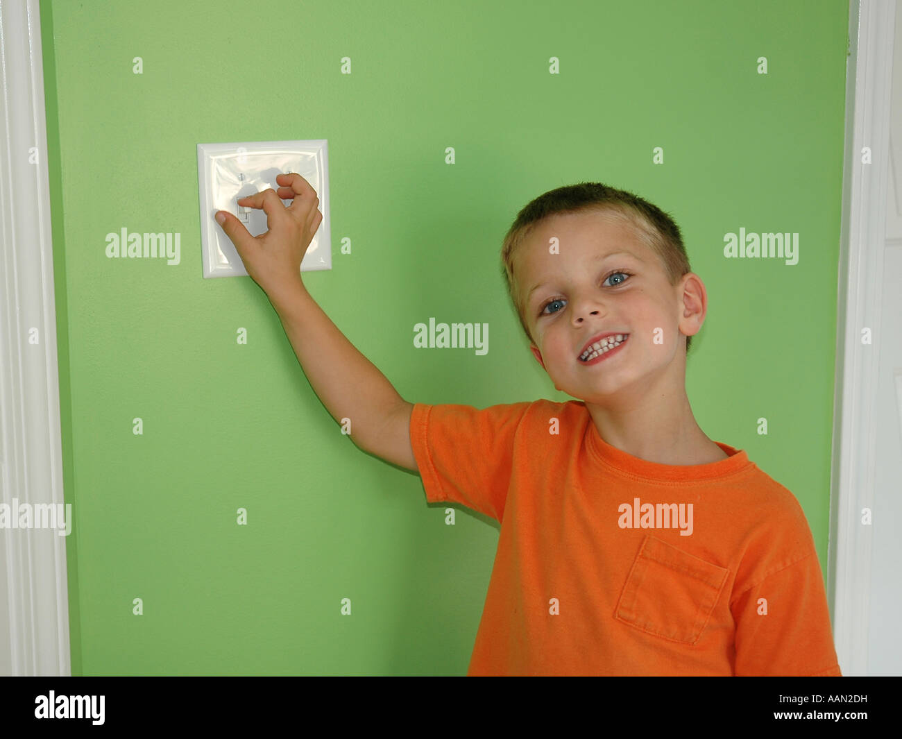 Young boy age four flips the light switch in his bedroom Stock Photo ...
