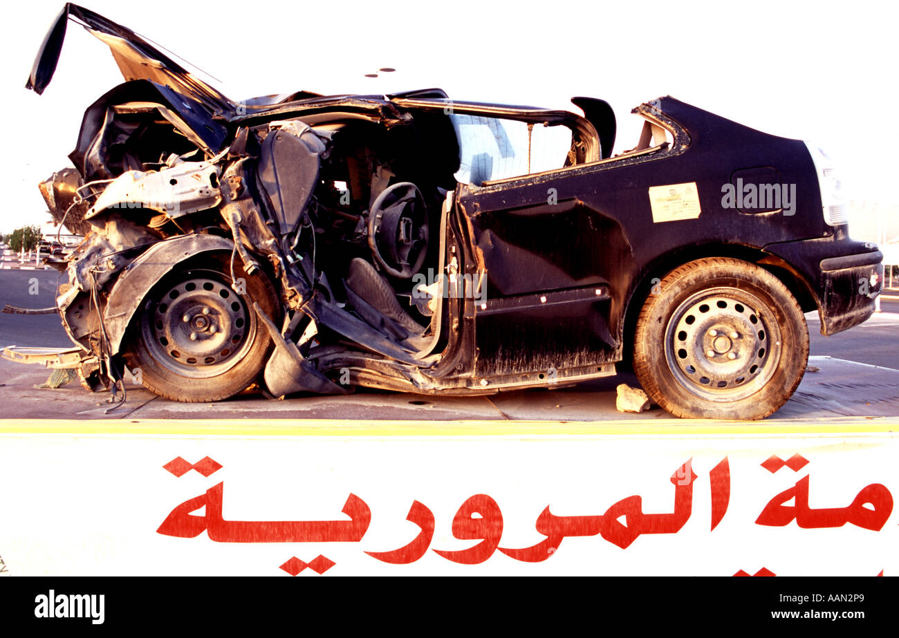 A wreaked car on display on exhibition roundabout in Doha Qatar Middle ...