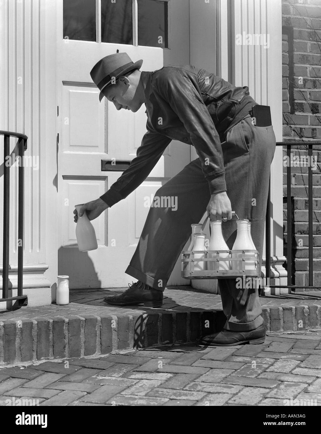 1940s MILKMAN SETTING GLASS BOTTLES OF MILK AND CREAM IN FRONT OF DOOR ...
