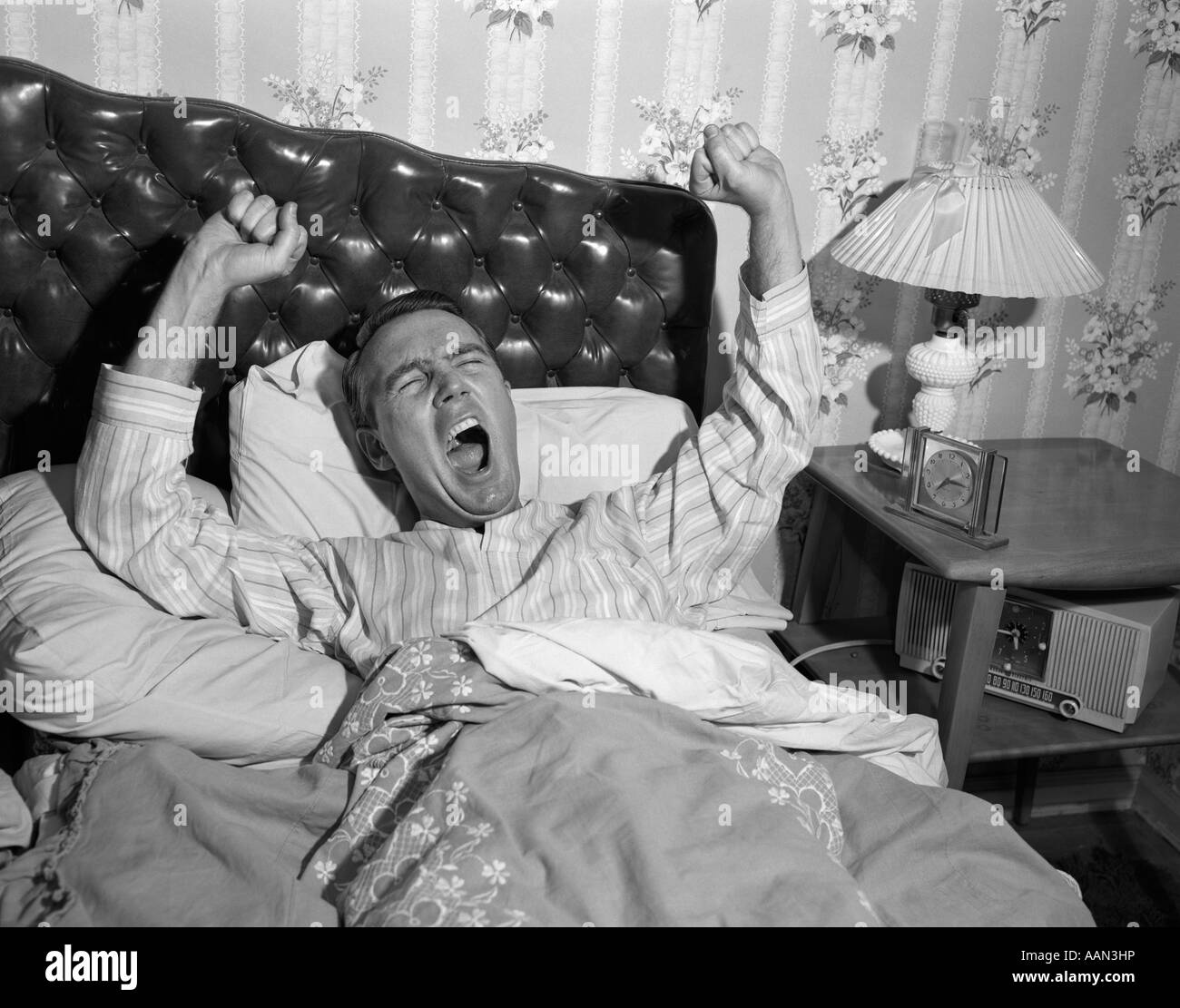 1950s YAWNING STRETCHING MAN WAKING UP IN BED WITH TUFTED LEATHER ...
