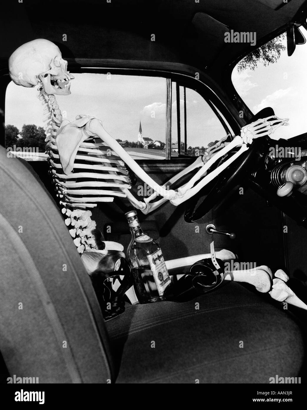1930s 1940s STILL LIFE OF SKELETON DRIVING CAR WITH WHISKEY BOTTLE AND ...