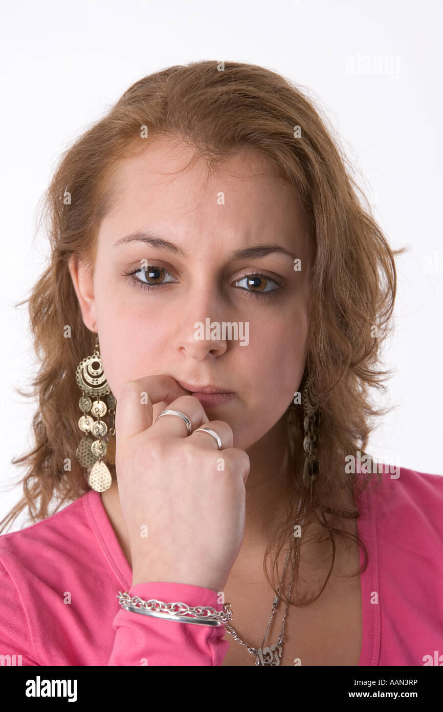 Portrait of a teenage girl biting nails Stock Photo - Alamy