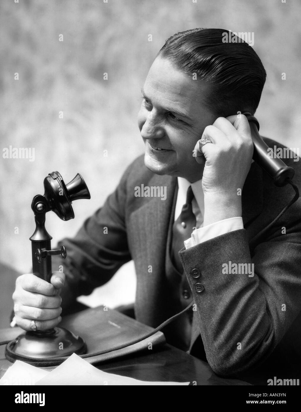 1920s BUSINESSMAN TALKING INTO CANDLESTICK TELEPHONE Stock Photo - Alamy