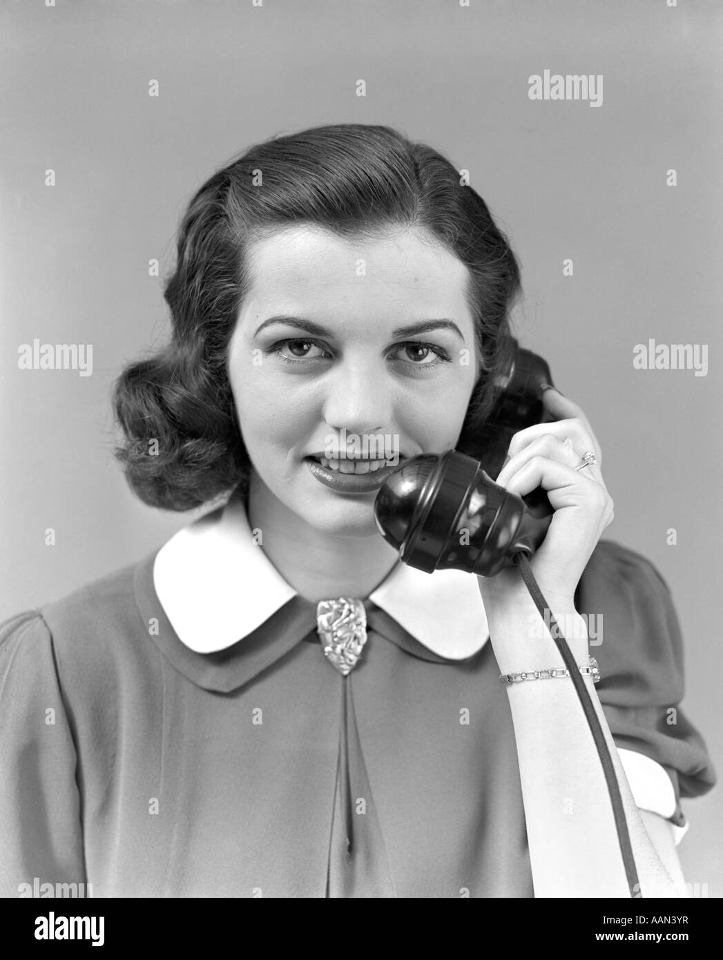 1930s 1940s BRUNETTE WOMAN SMILING HOLDING TELEPHONE TO EAR DRESS WITH ...