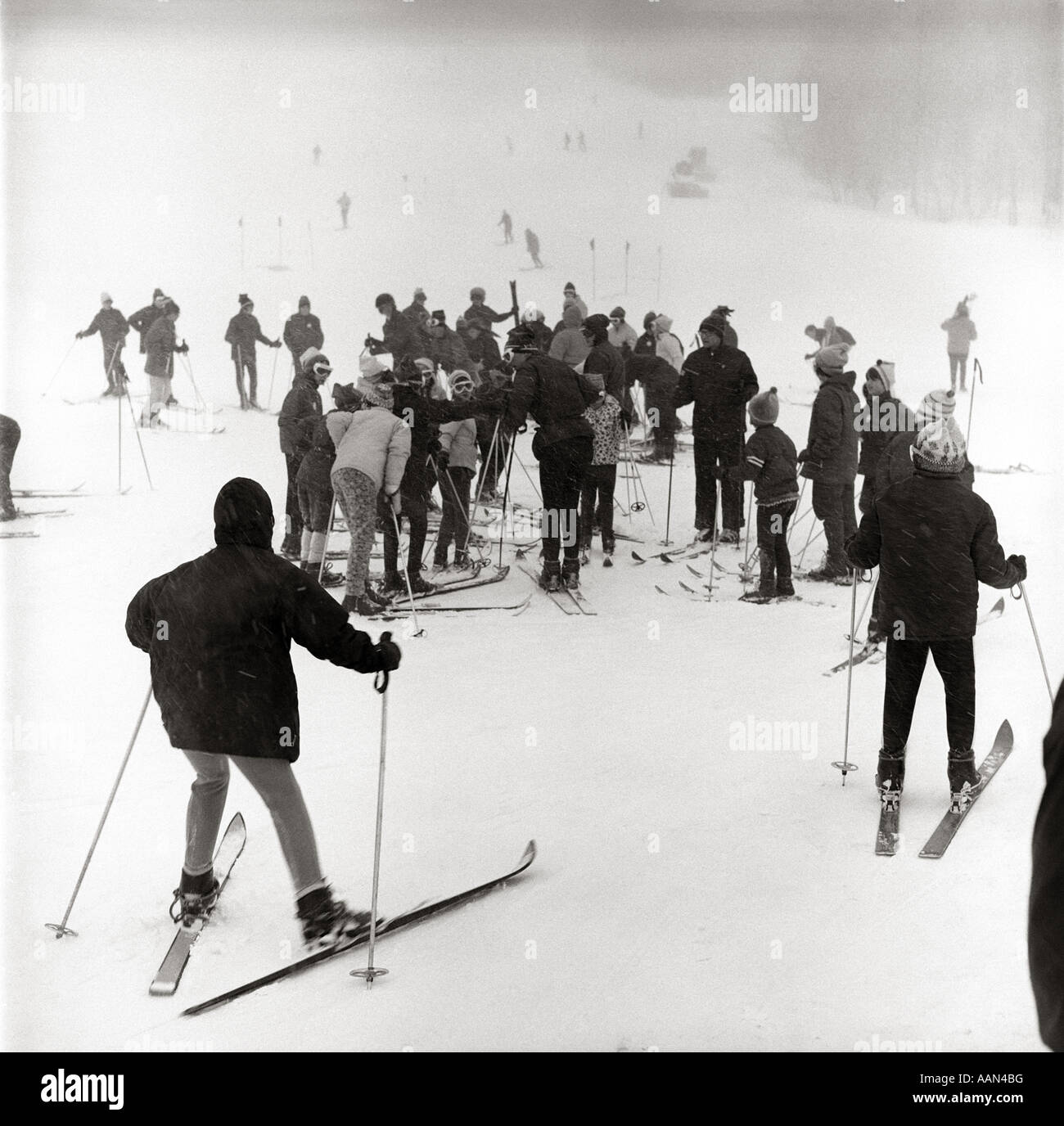 1960s WINTER SKIING GROUP MEN WOMEN CHILDREN SNOW WINTER SKI SLOPES ...