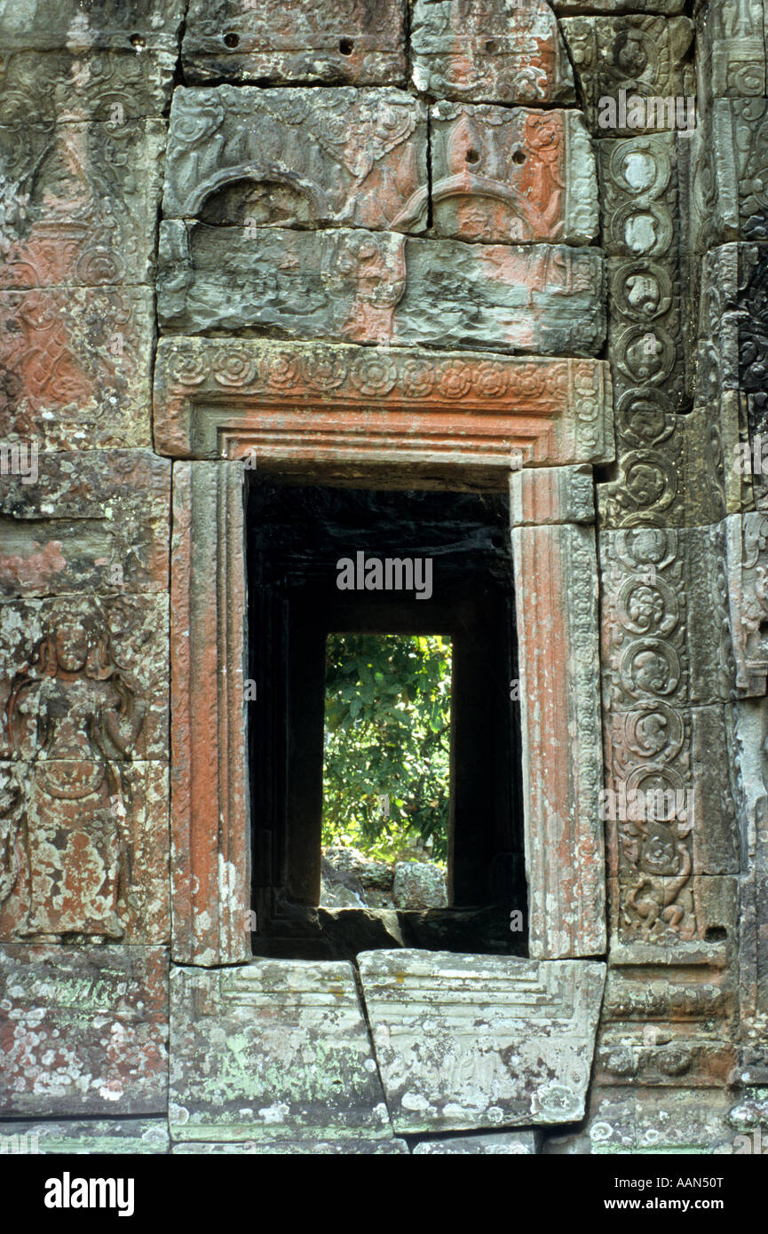 Rust coloured lichen growing on carved stonework around window opening ...