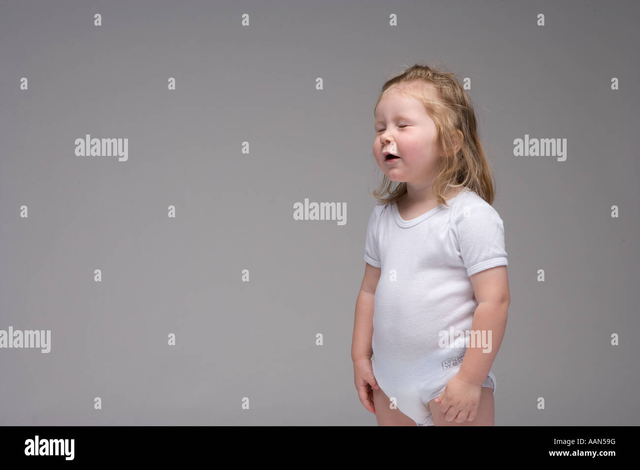 Little girl with her eyes closed for a surprise Stock Photo - Alamy