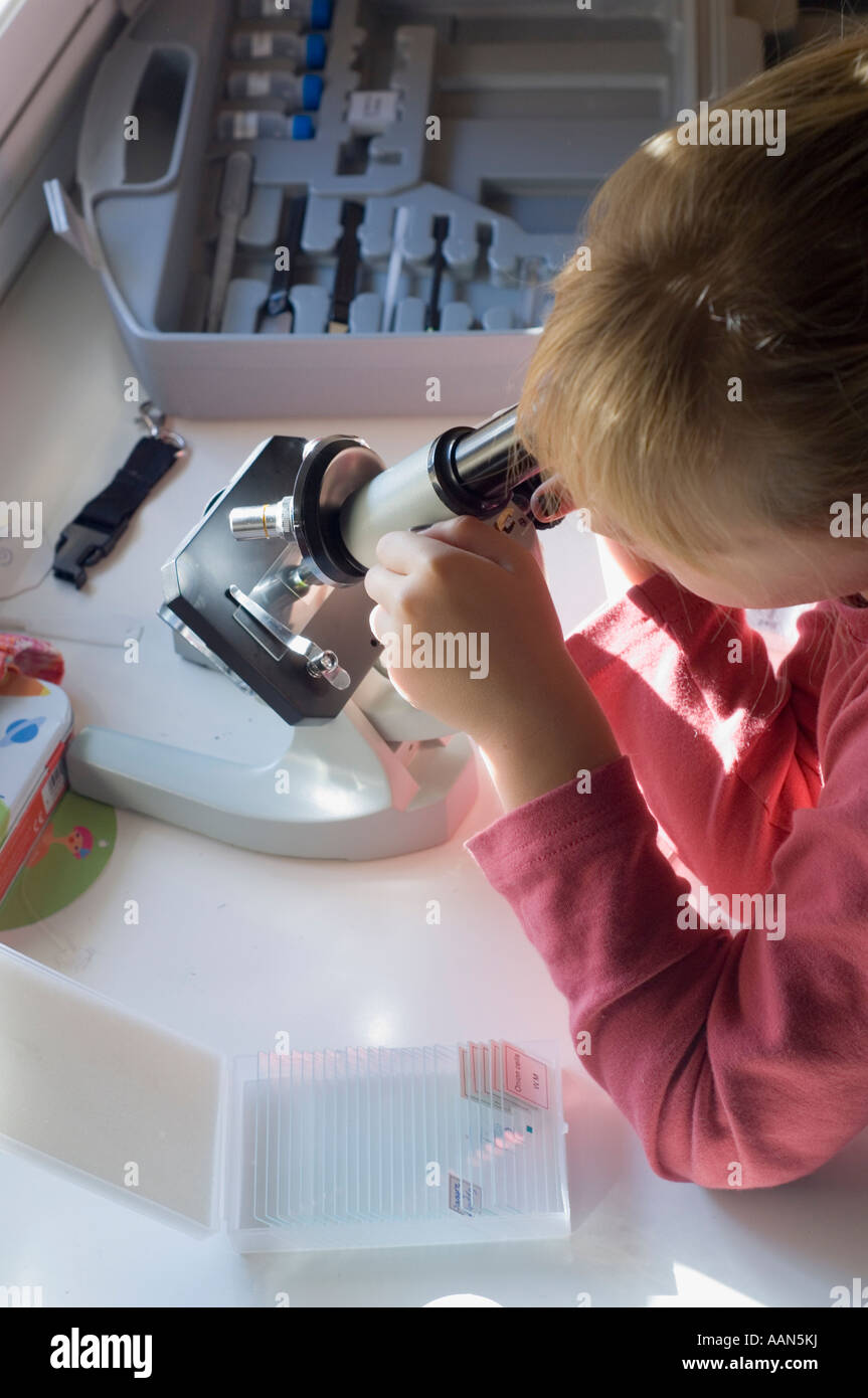 Young girl with a microscope Stock Photo - Alamy