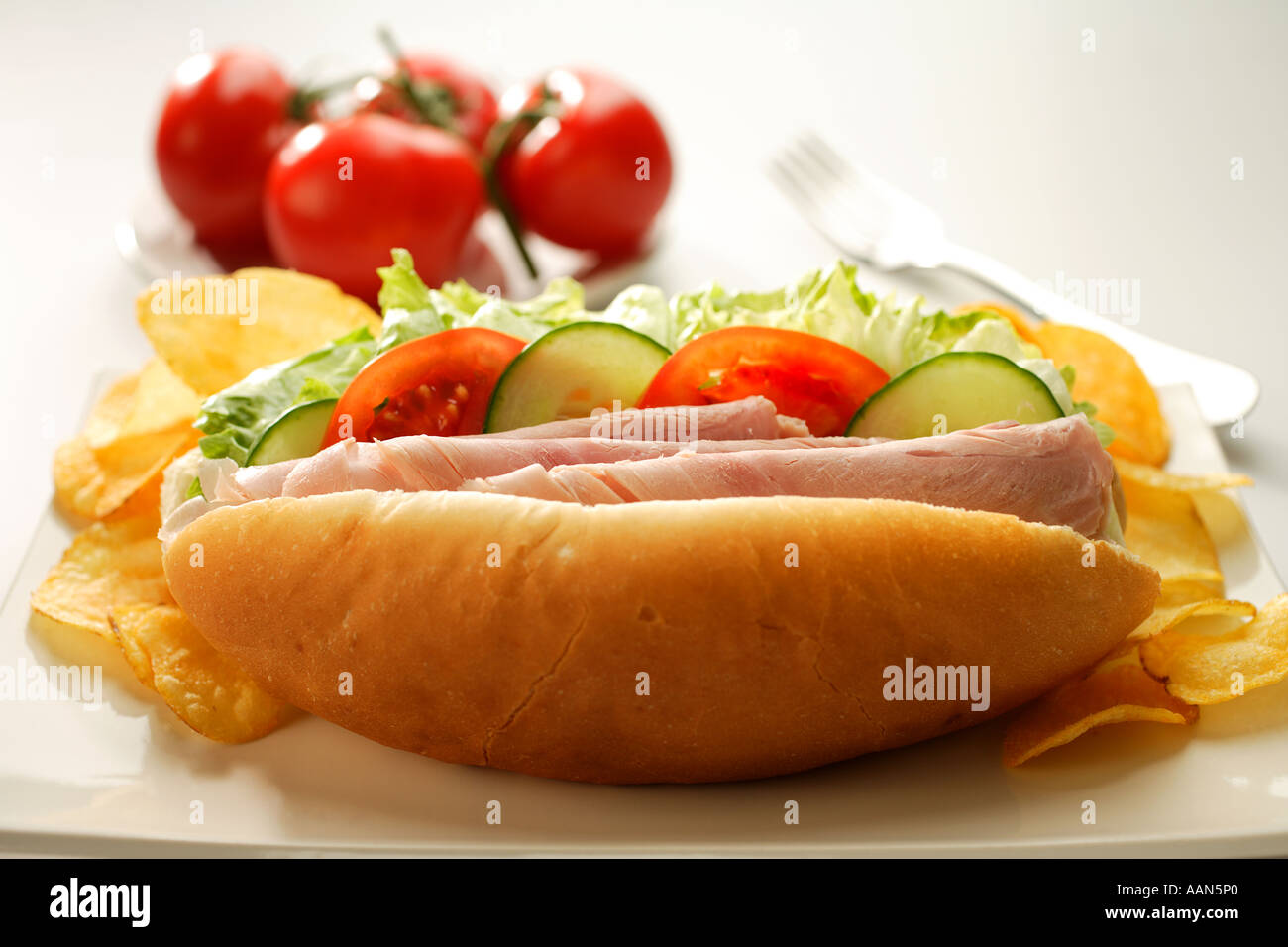Ham salad torpedo roll on plate with potato chips Stock Photo - Alamy