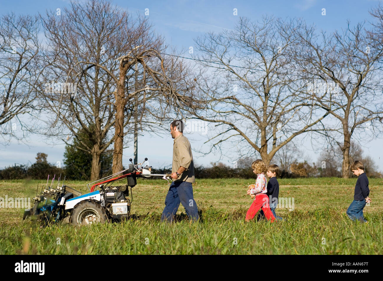 kids following the gardener Stock Photo - Alamy