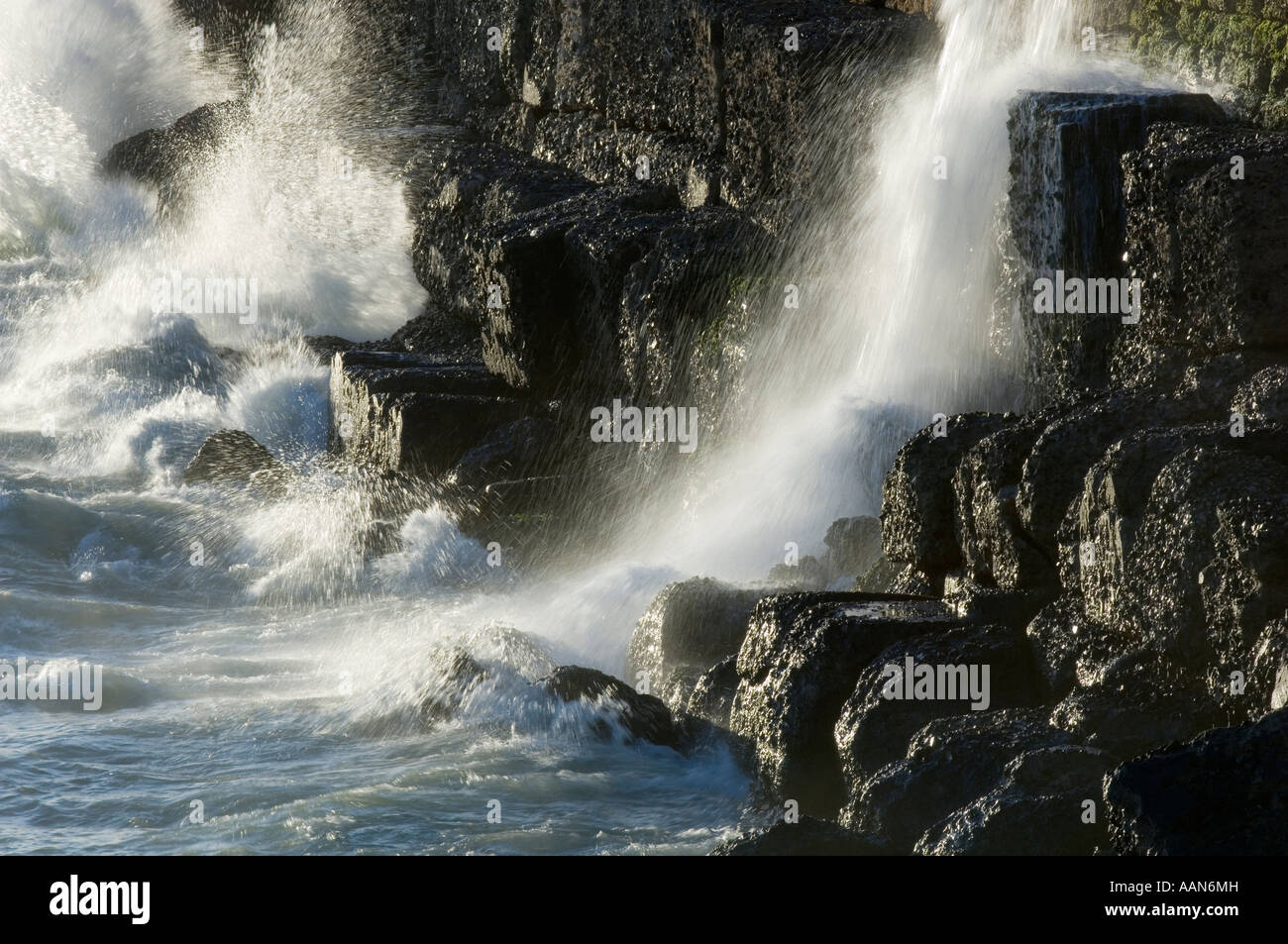rough sea breaking against rocks Stock Photo - Alamy