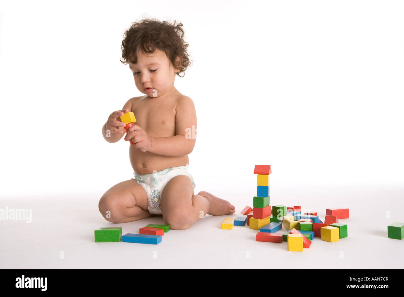 Little boy playing with colored bricks on the floor Stock Photo - Alamy