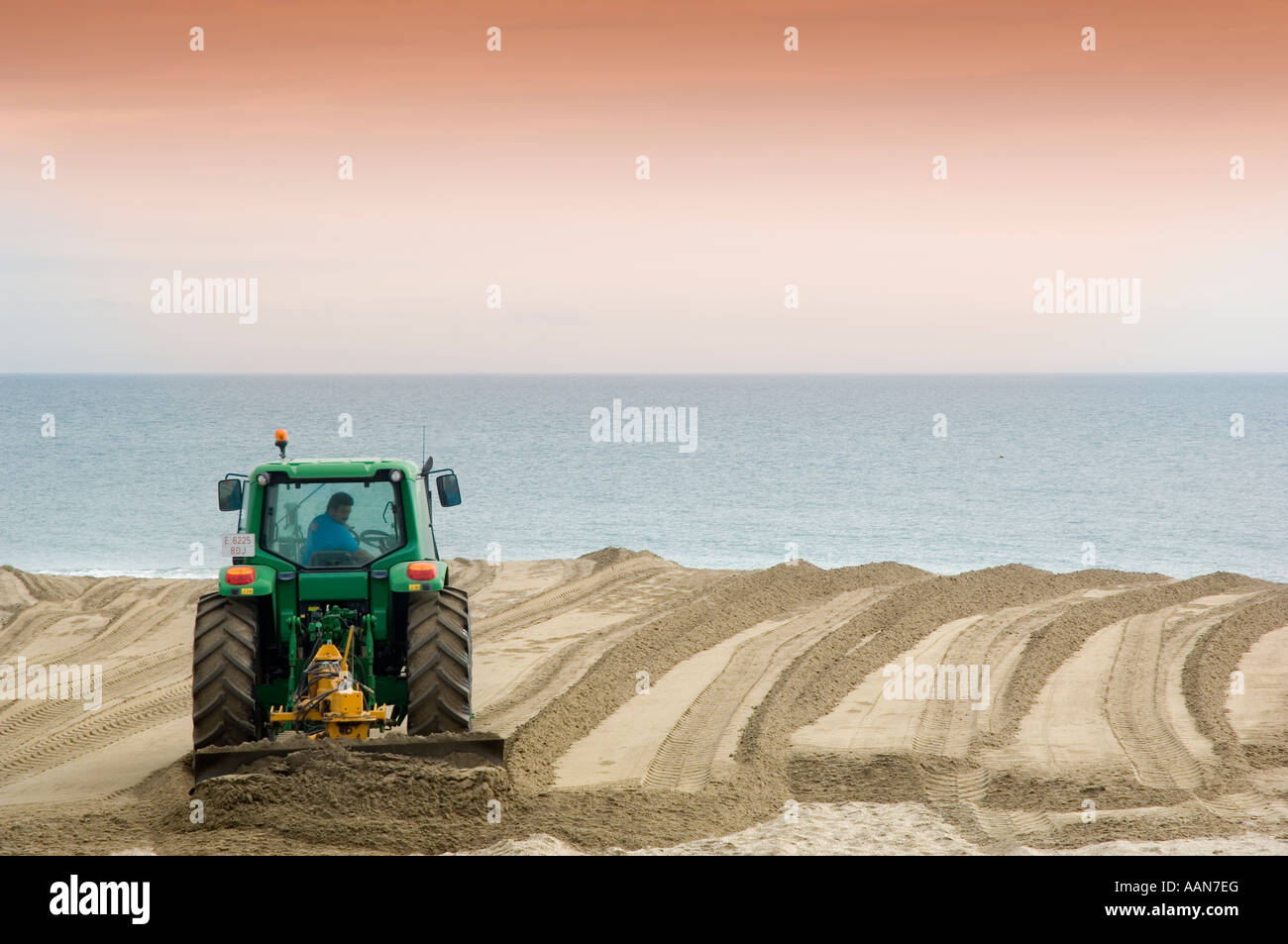 tractor cleaning beach Stock Photo - Alamy