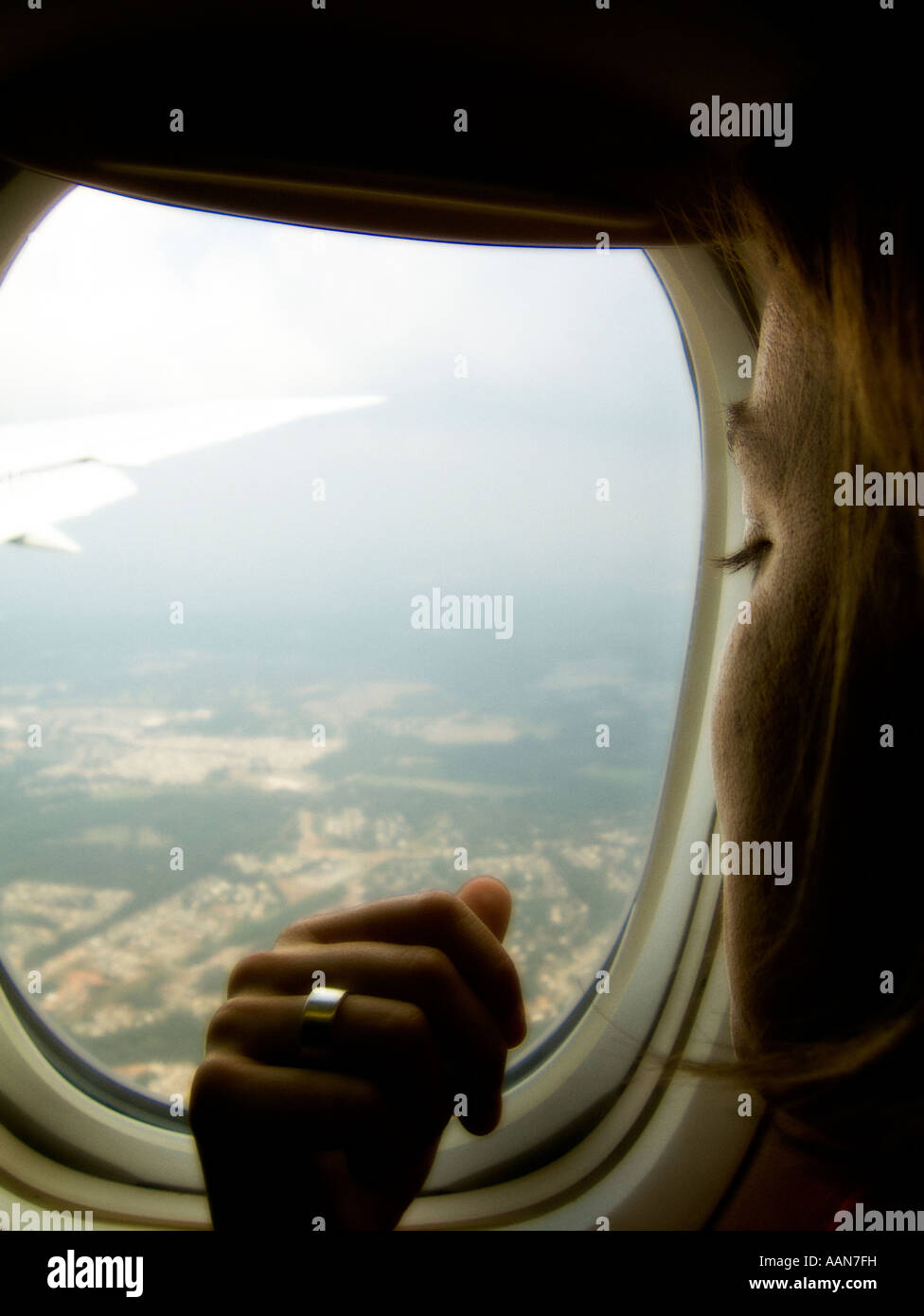 Passenger looking to the landscape through a plane window Stock Photo ...