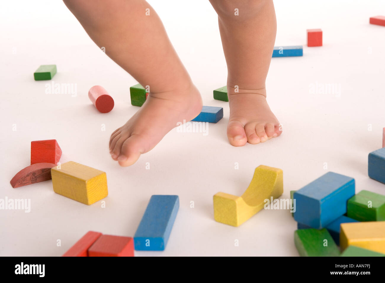 Child s feet surrounded by bricks on the floor Stock Photo - Alamy