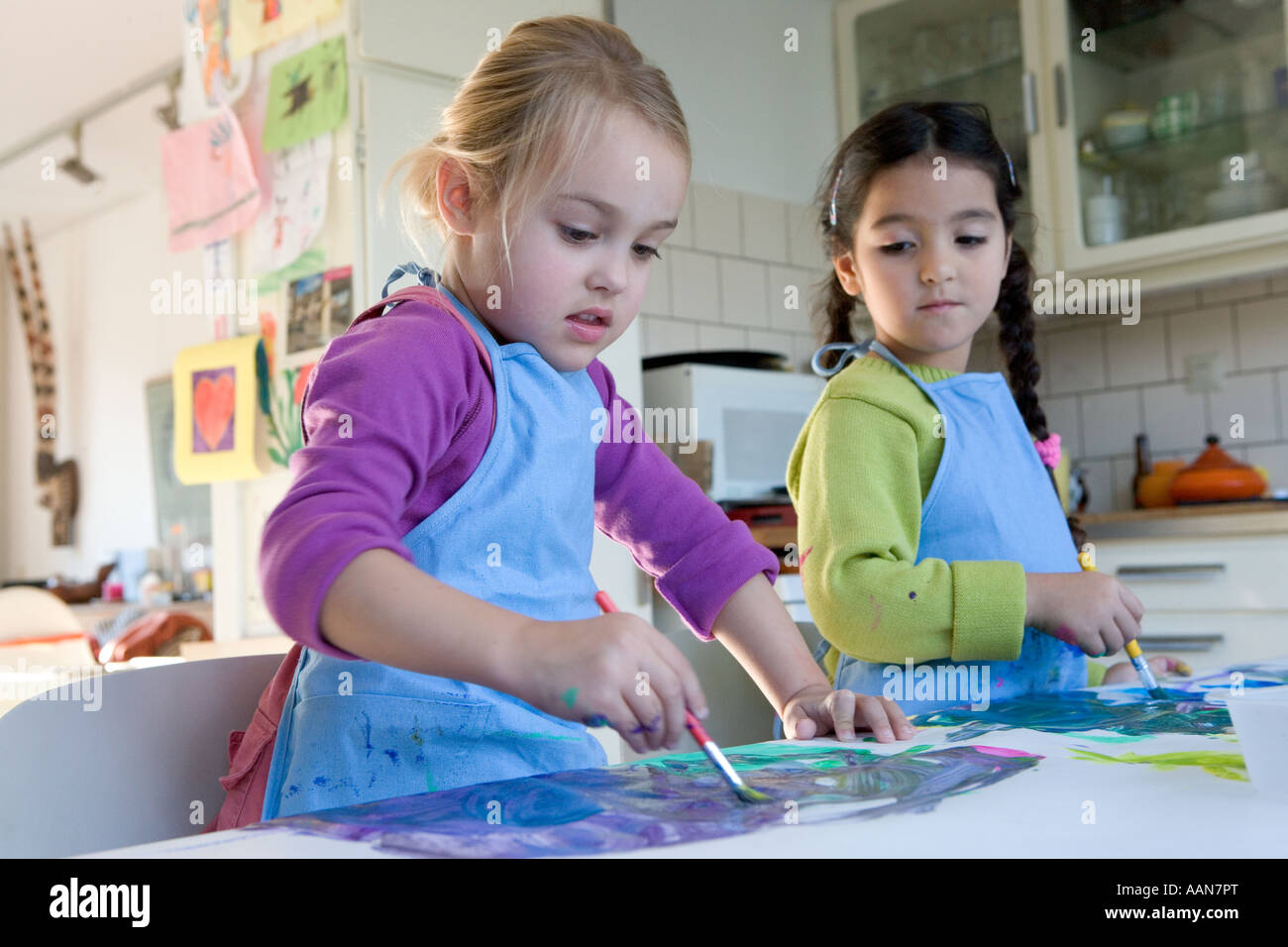 Two little girls are making a painting Stock Photo - Alamy
