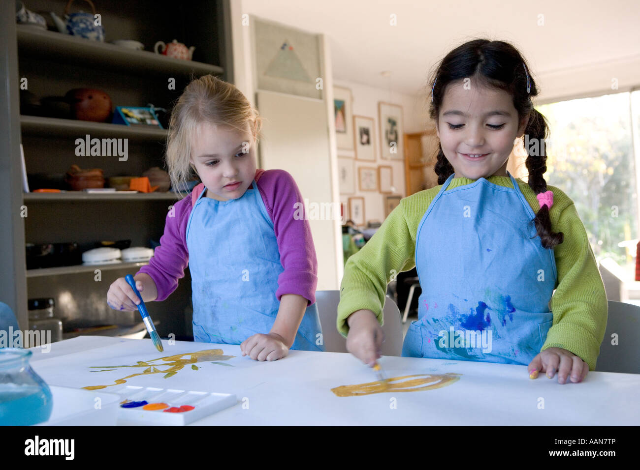 Two little girls are making a painting Stock Photo - Alamy