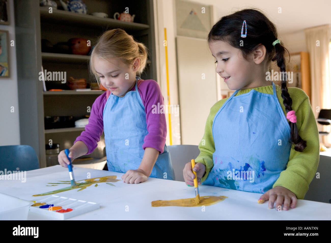 Two little girls are making a painting Stock Photo - Alamy