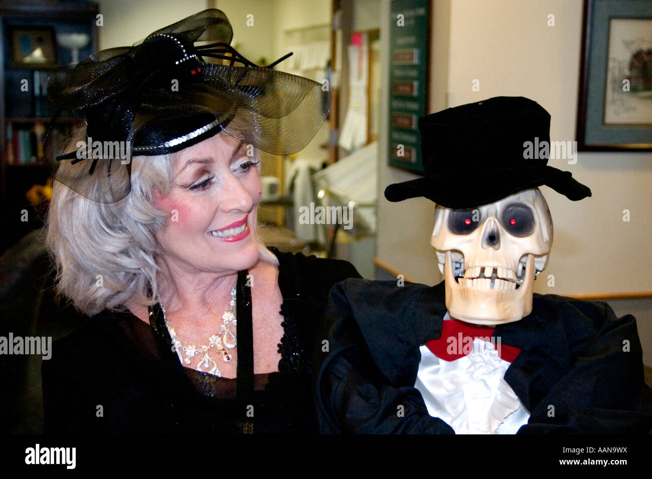Woman age 60 dressed for Halloween with skeleton puppet. Minnesota ...