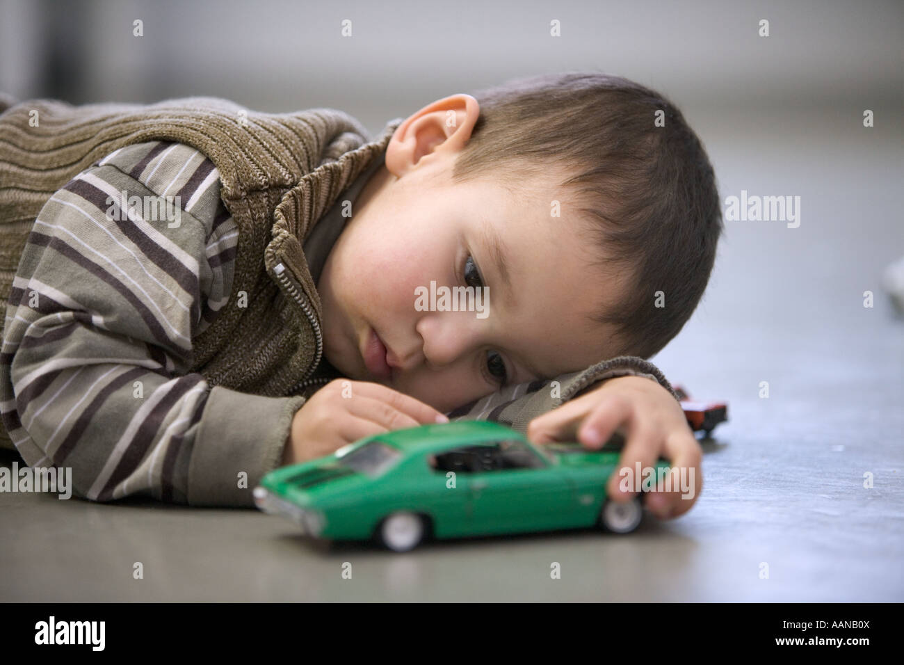 Little boy playing with toy car Stock Photo - Alamy