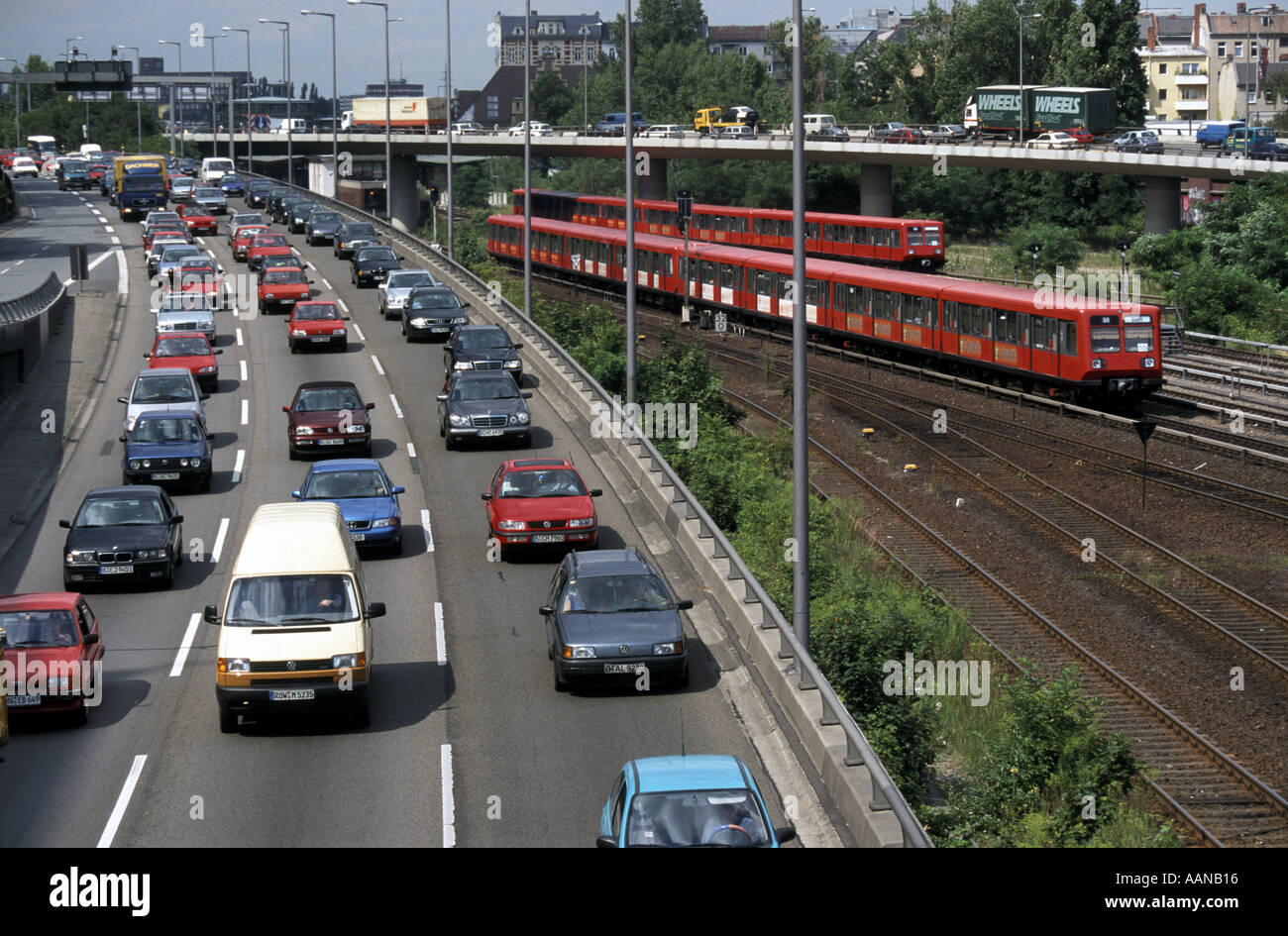 Germany Berlin S Bahn train beside crowded motorway Stock Photo - Alamy
