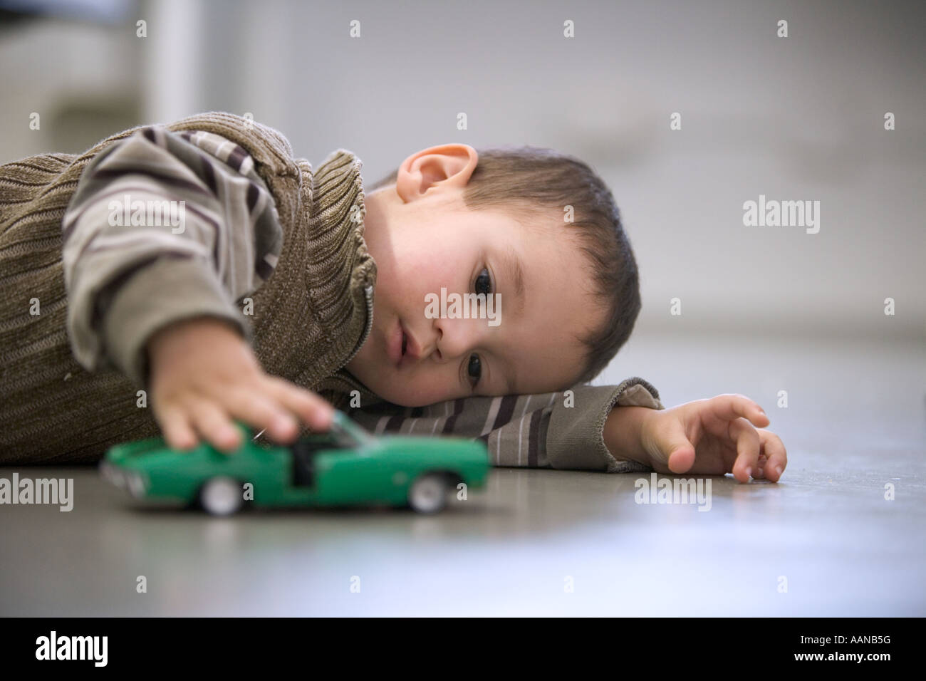 Little boy playing with toy car Stock Photo - Alamy