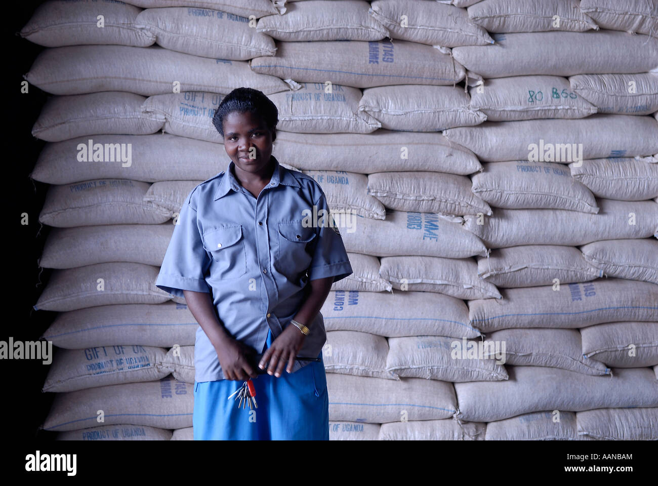 A woman stands amid sacks of basic foodstuffs at a storage warehouse of ...