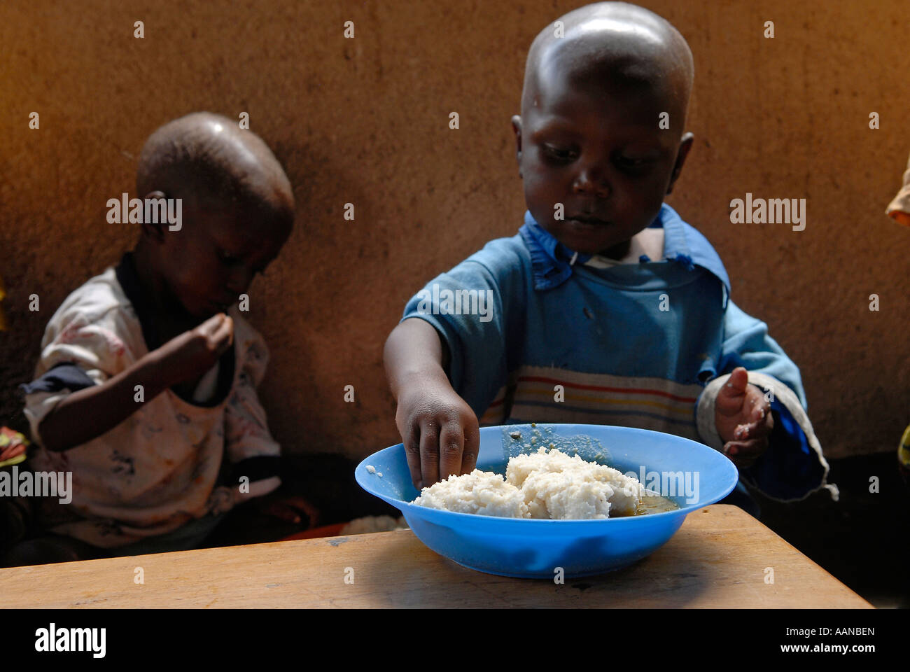 Displaced Congolese children eat mashed cassava with their hands at a ...