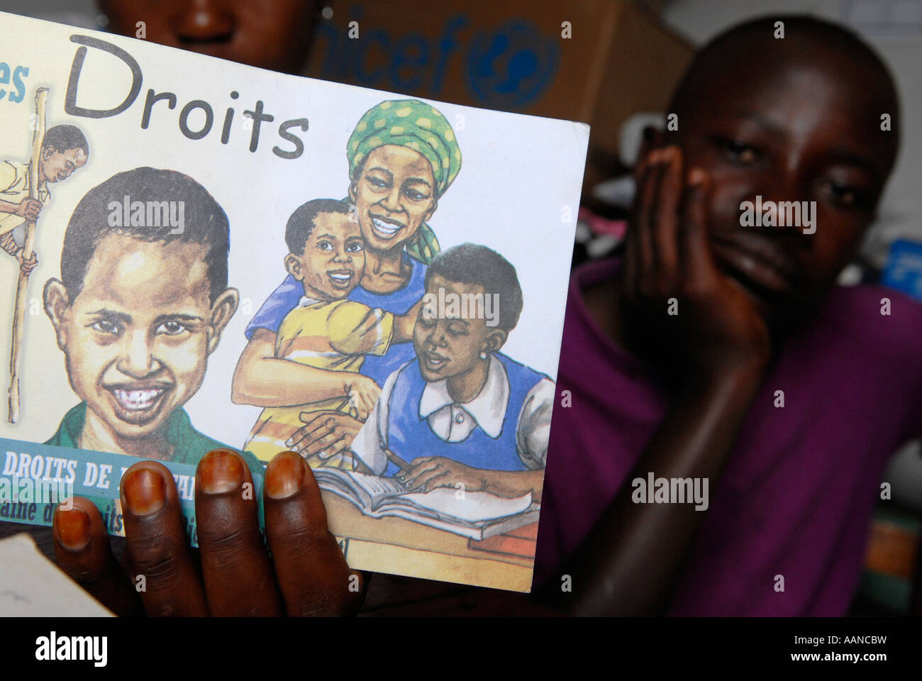 A former child soldier holds a book in French which reads Droits or ...