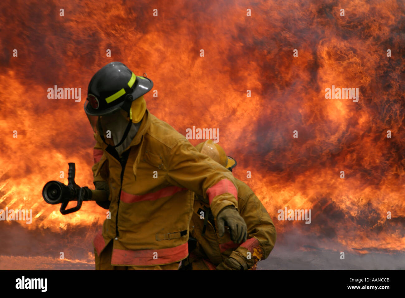 Firefighters Retreating from Structure Fire Stock Photo - Alamy