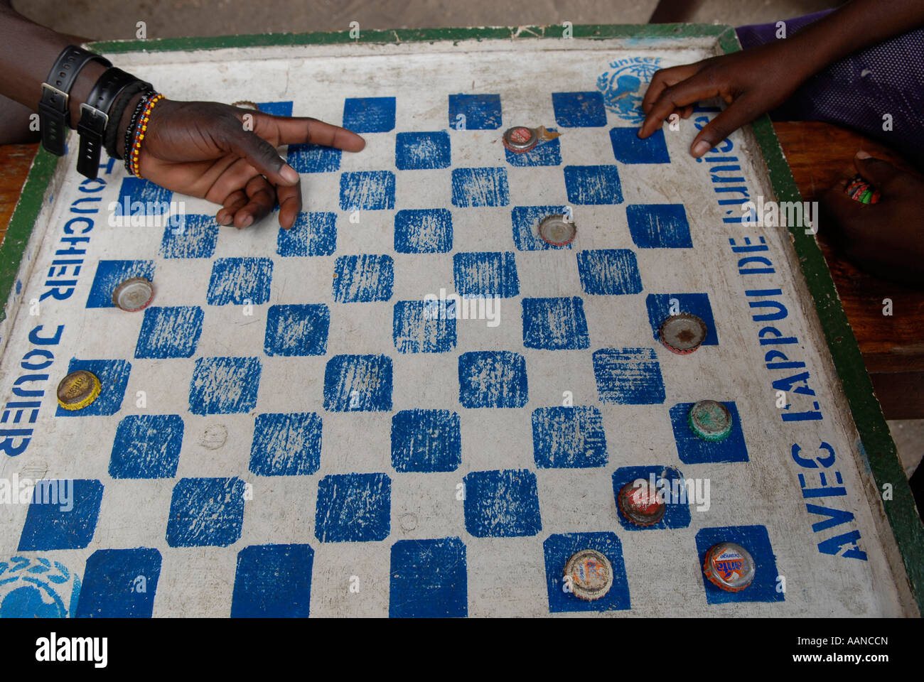 Former child soldiers play checkers board game at a rehabilitation ...