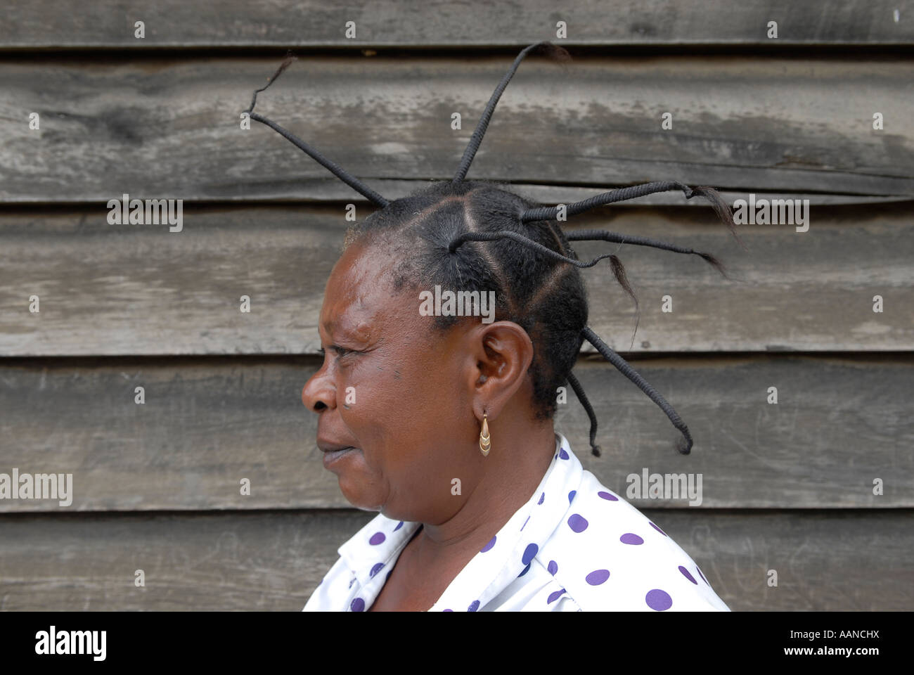 A woman with a traditional threading hairstyle wherein the hair is ...