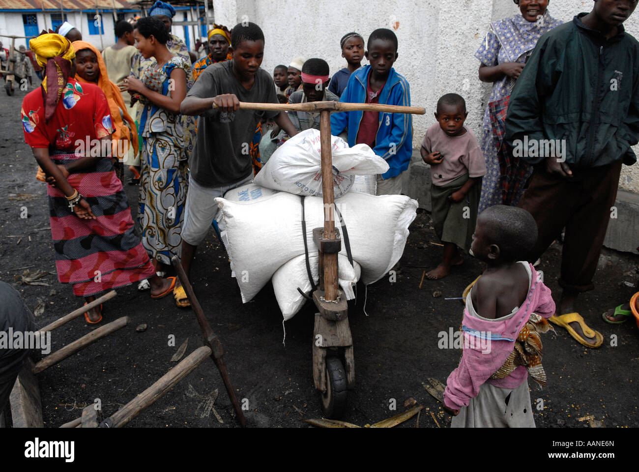 Man carrying sacks of supplies after food distribution carried out by ...