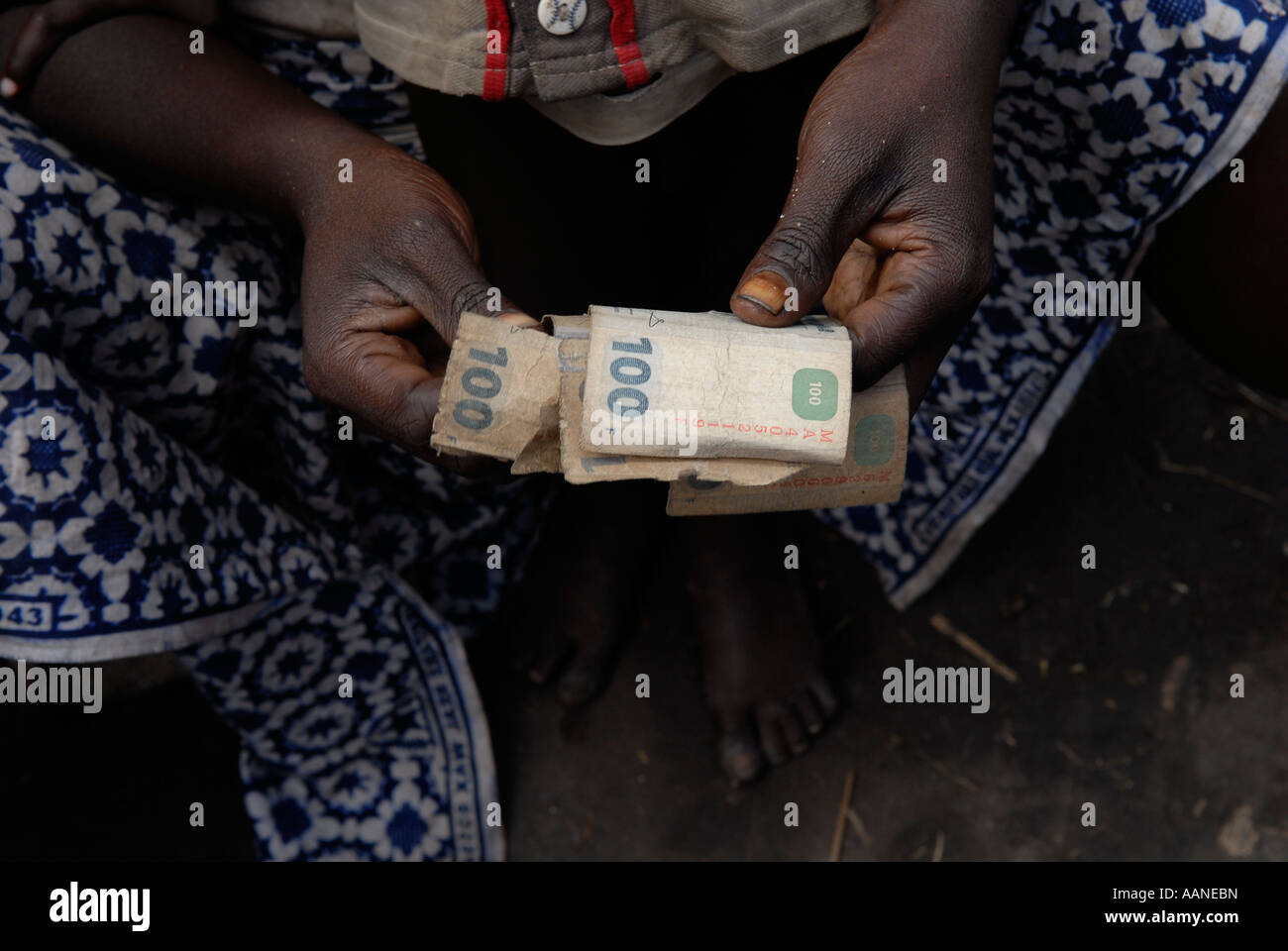 A person holding a banknote of 100 Congolese franc in North Kivu ...