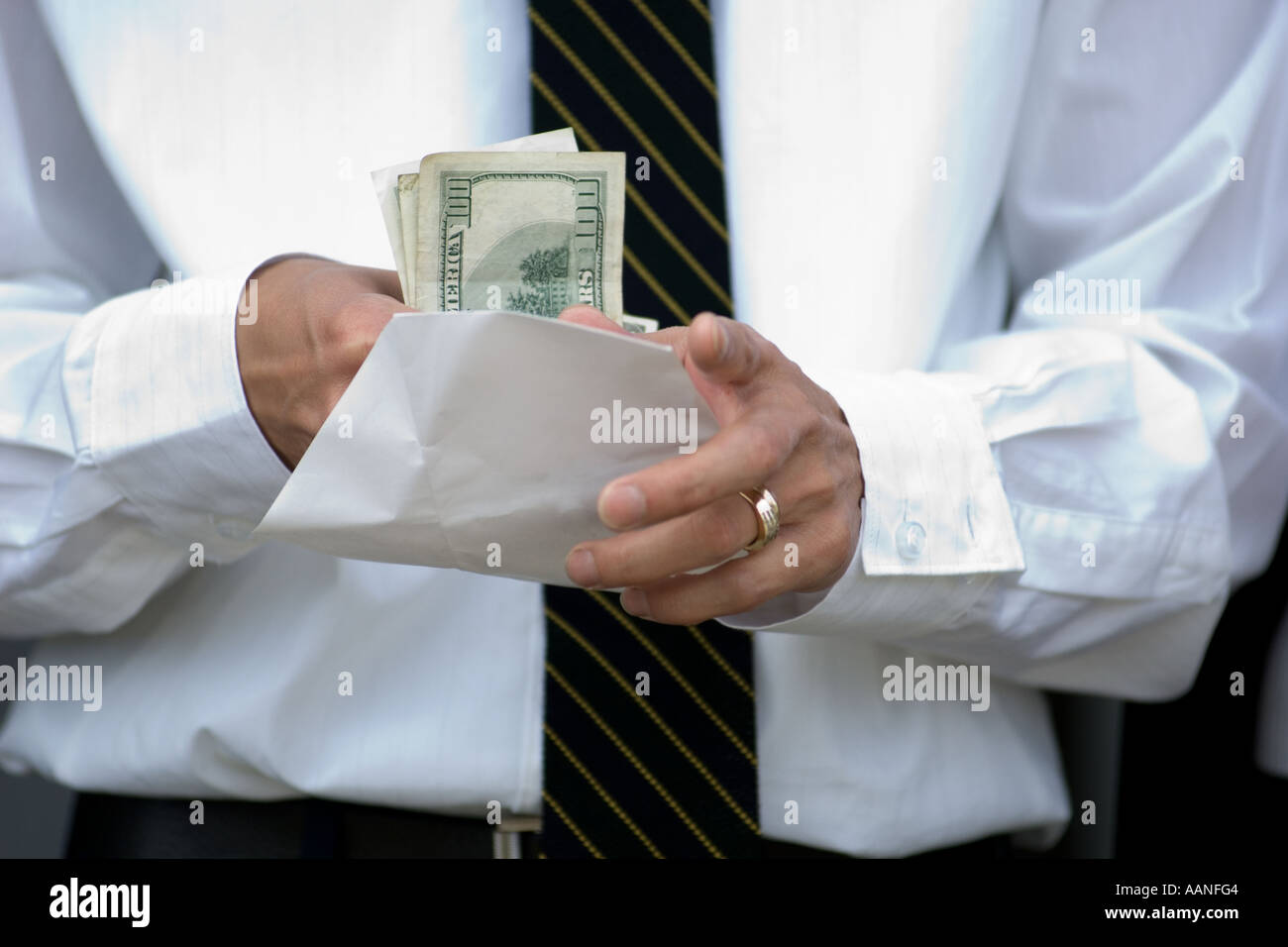 Man placing cash in envelope Stock Photo - Alamy
