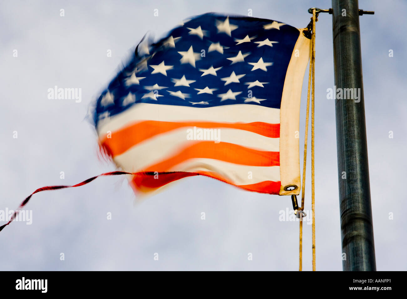 American flag torn ripped blowing usa Stock Photo - Alamy