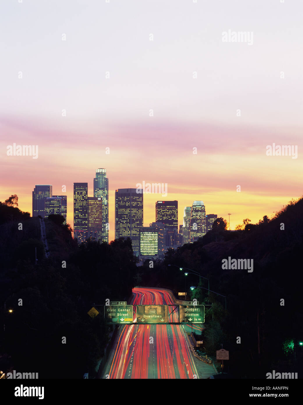 Retro image Sunset over LA Downtown District with skyscrapers with car ...