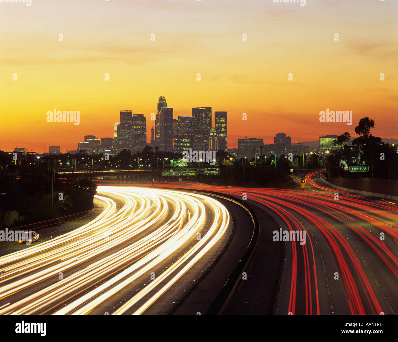 Retro Image Sunset over LA Downtown District with skyscrapers with car ...