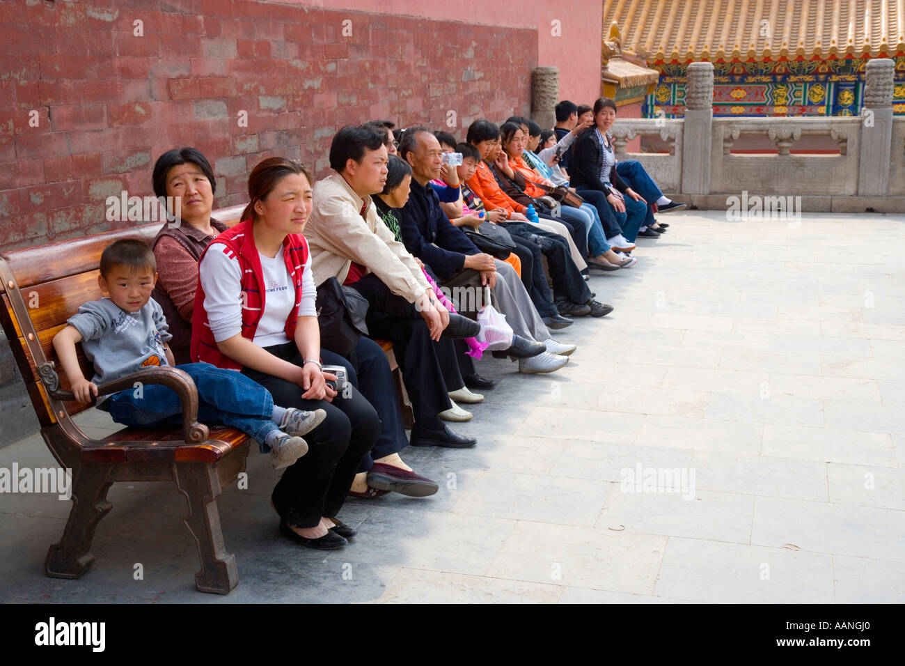 Chinese tourists resting on bench at The Forbidden City Beijing China ...
